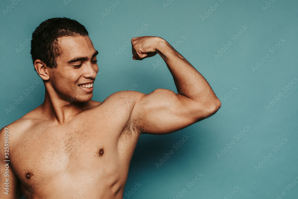 Young arabian or egyptian man proud od muscles he has on hands. Strong ...