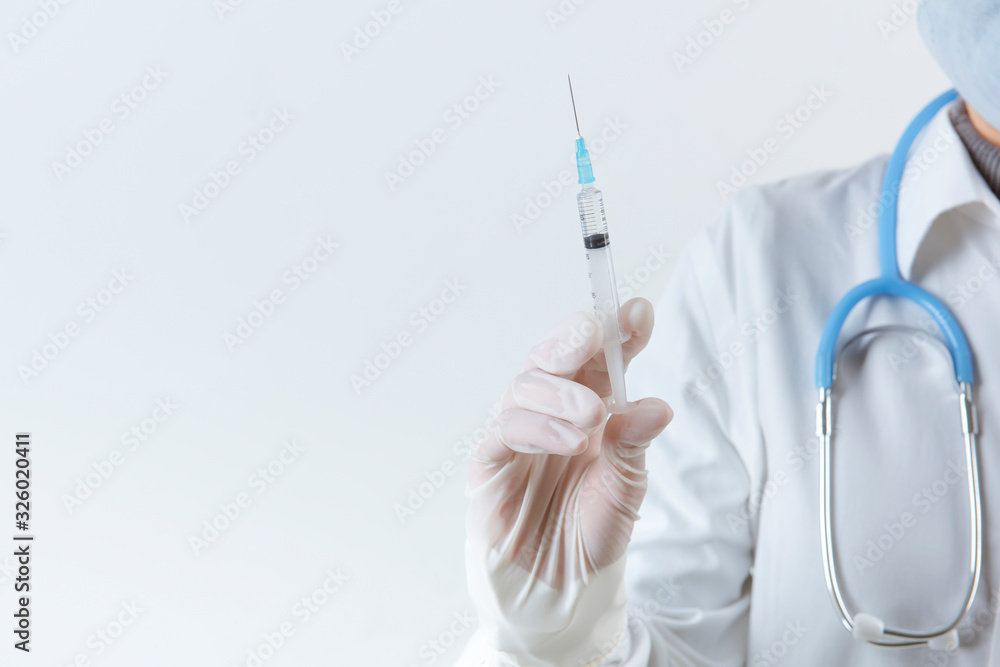 Doctor hand in white glove hold syringe with preparation jet from the ...