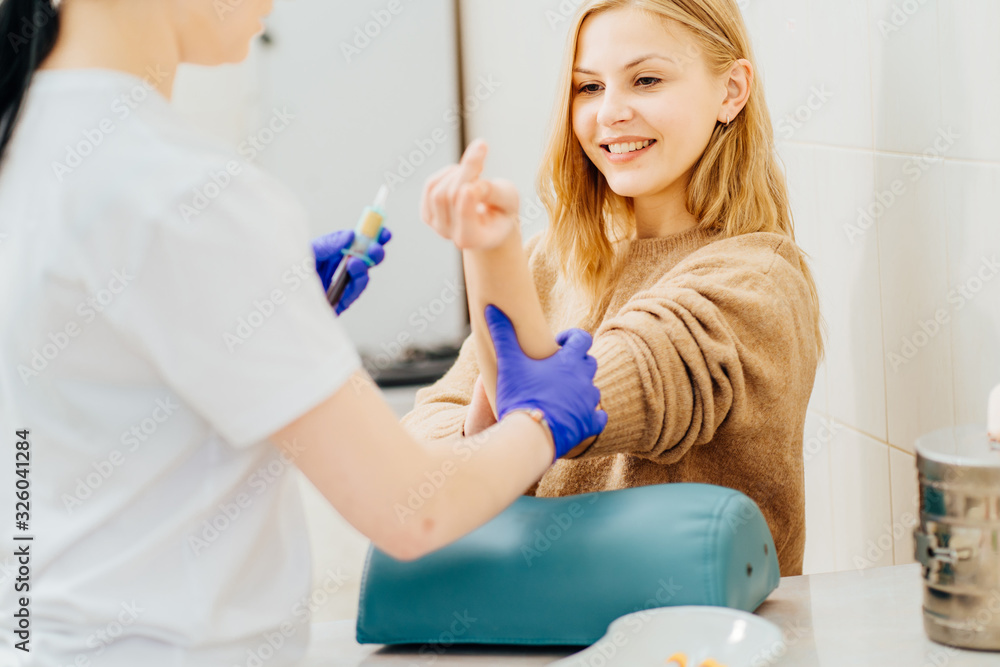 Laboratory nurse takes real blood sample phlebotomist with vacuum ...