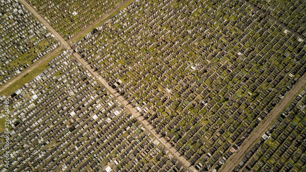 Gravestones and cemetery. Vertical aerial drone view looking down onto ...