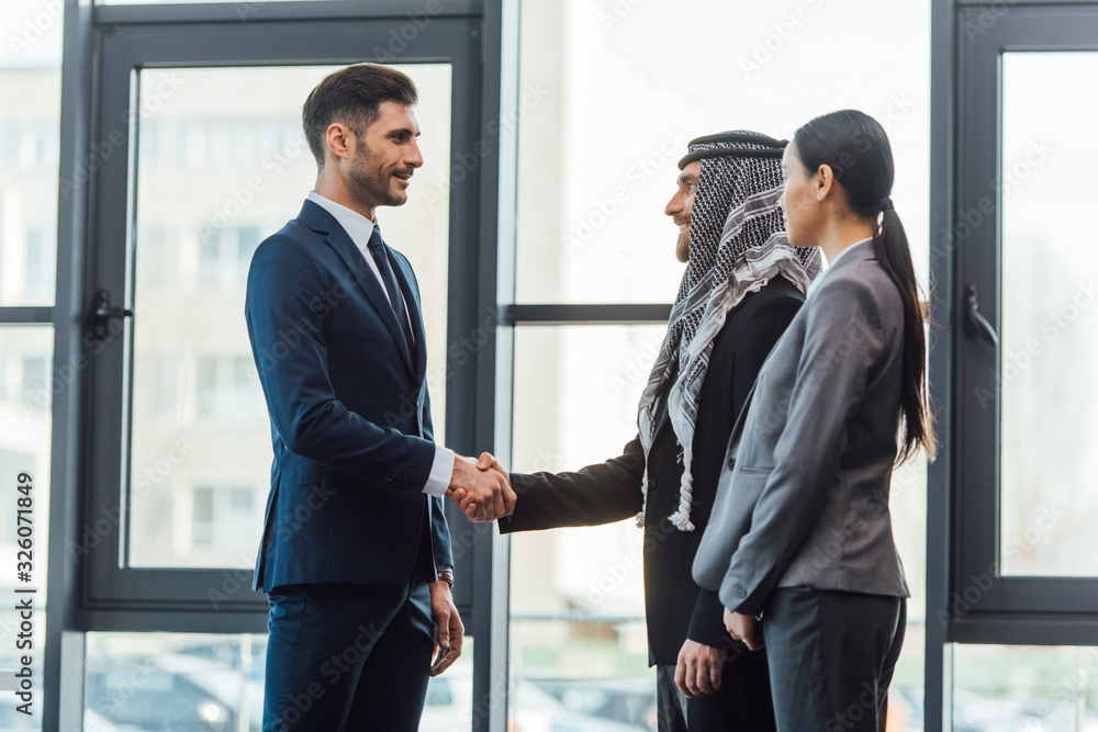 professional multicultural business partners shaking hands on meeting ...
