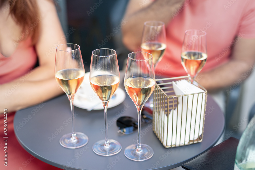 Close-up detail table with many filled glasses of white champagne ...