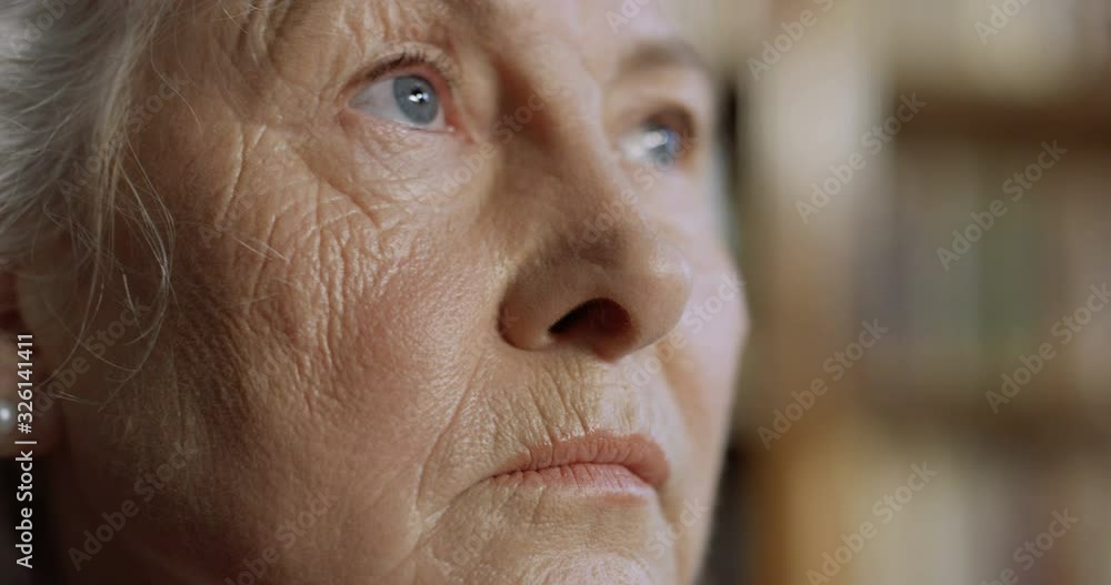 Close up of face with wrinkles of Caucasian old woman ith gray hair and ...