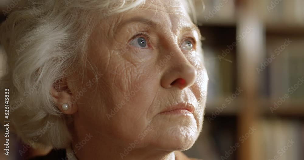 Close up of face with wrinkles of Caucasian old woman ith gray hair and ...