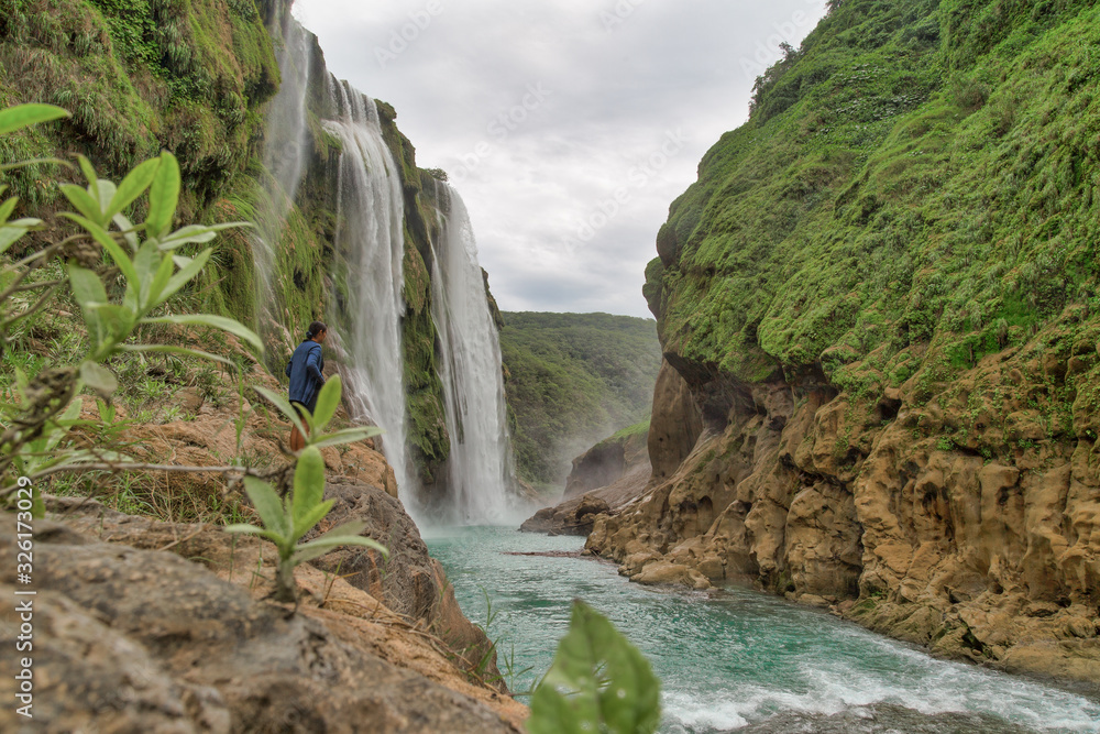 Green Background Scenic view of spectacular Tamul Waterfall, Tampaon ...
