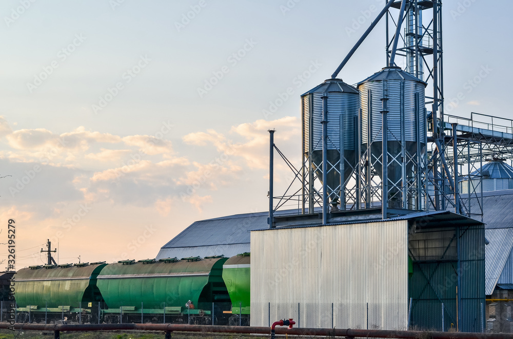 Loading railway carriages with grain at grain elevator. Copy space ...