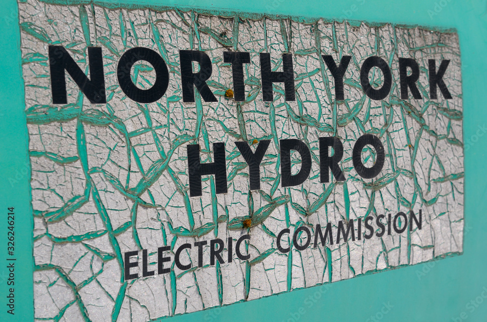 Ancient green sign for North York Hydro on an abandoned junkyard truck ...