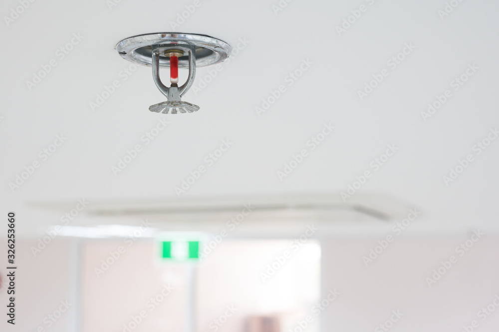 Fire fighting equipment, sprinkler on white ceiling background ...