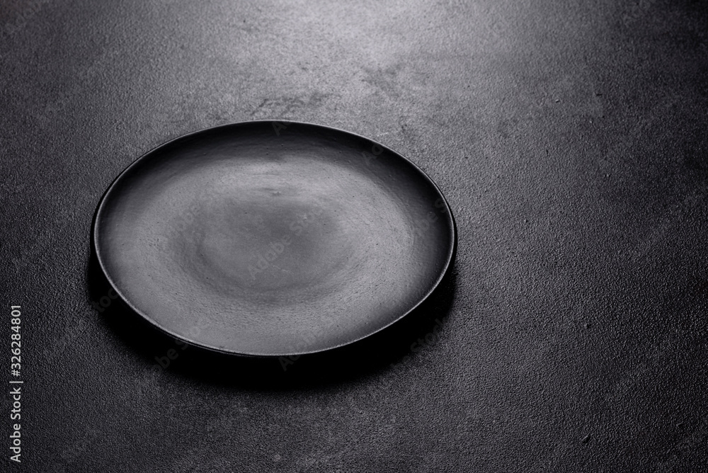 Empty black plate over dark stone background with free space Stock ...
