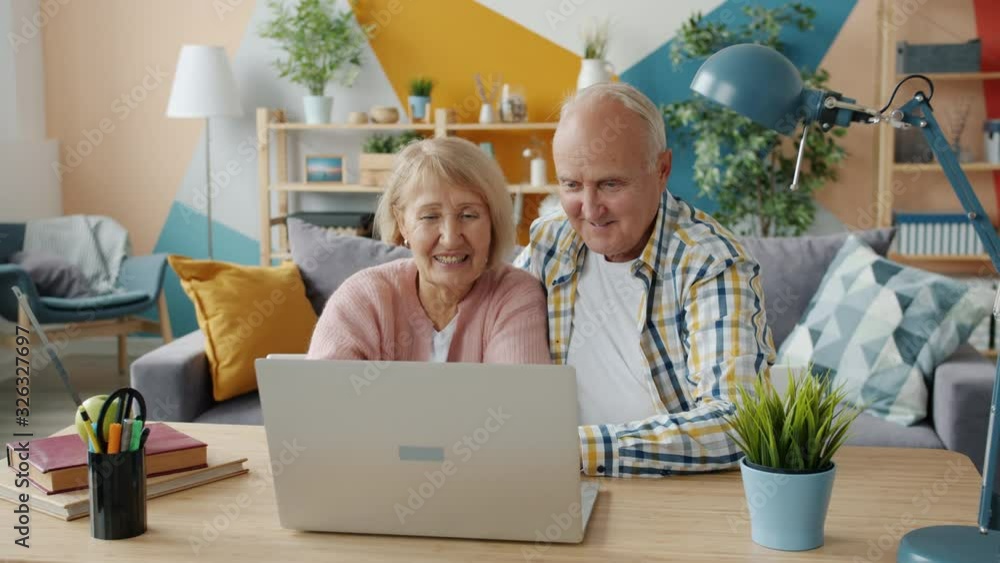 Happy elderly people are using laptop to make video call talking ...