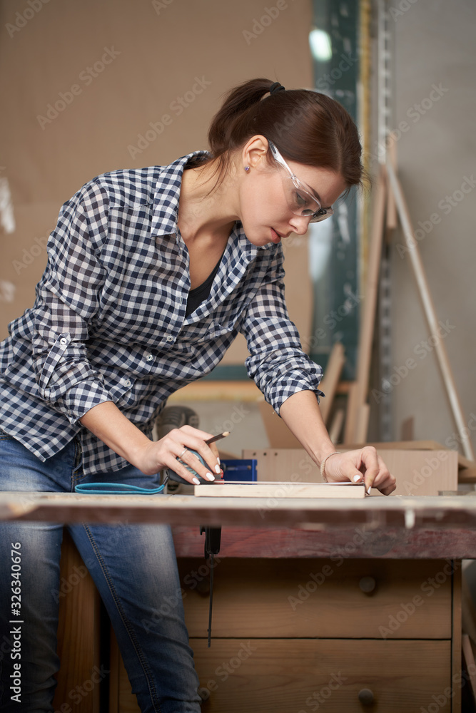 Girl carpenter in glasses with tape measure and blackboard Stock Photo ...