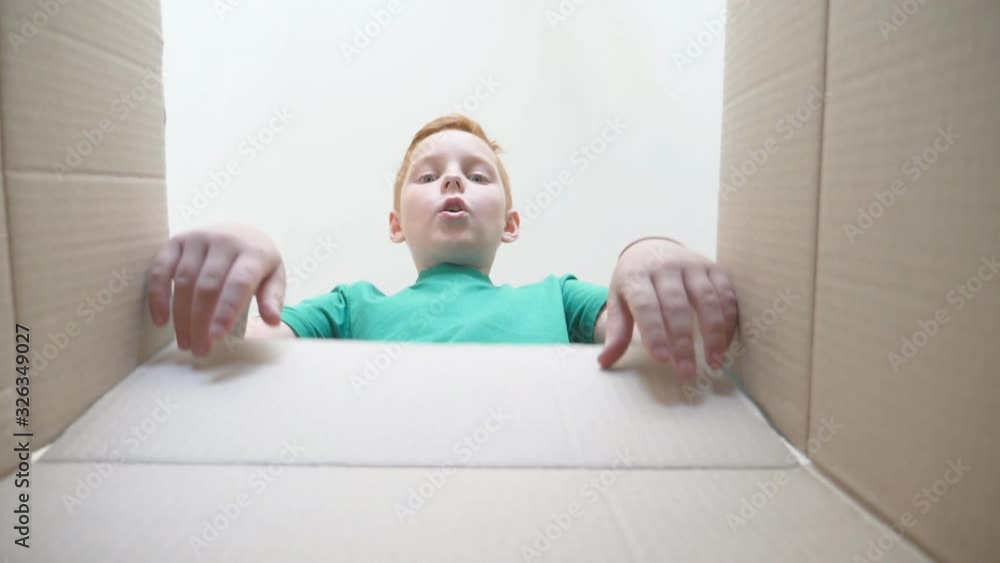 Child opening box with gift and pulling hands to take it. Little boy ...