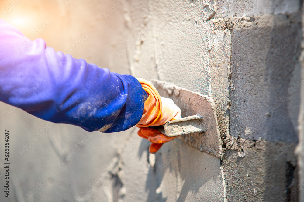 Mason plastering the concrete to build wall,Construction under building ...