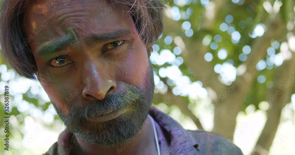 Closeup CU of an Indian man happy enjoying playing with a smiling face ...