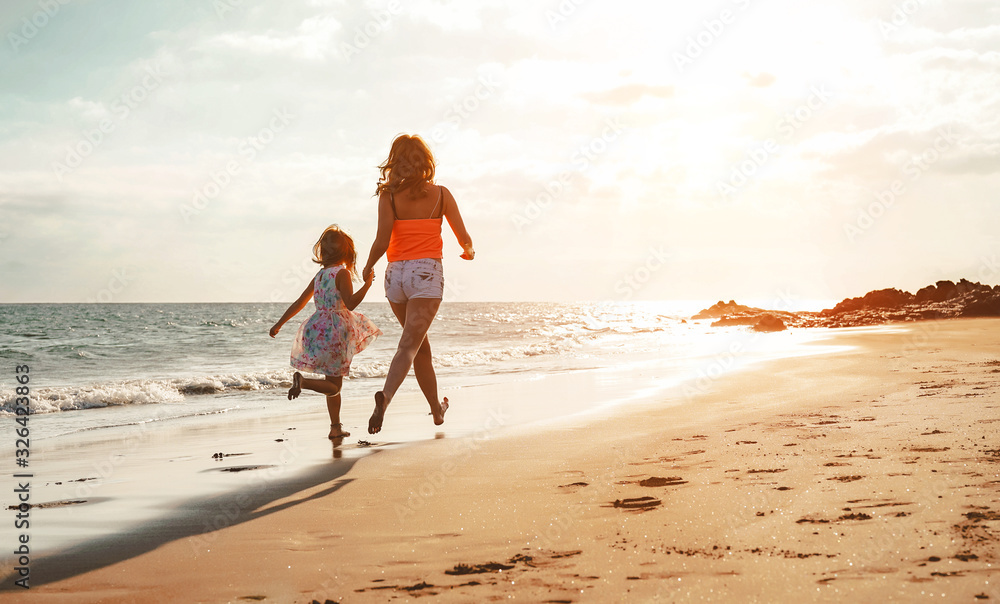 Happy loving family mother and daughter having fun on the beach at ...