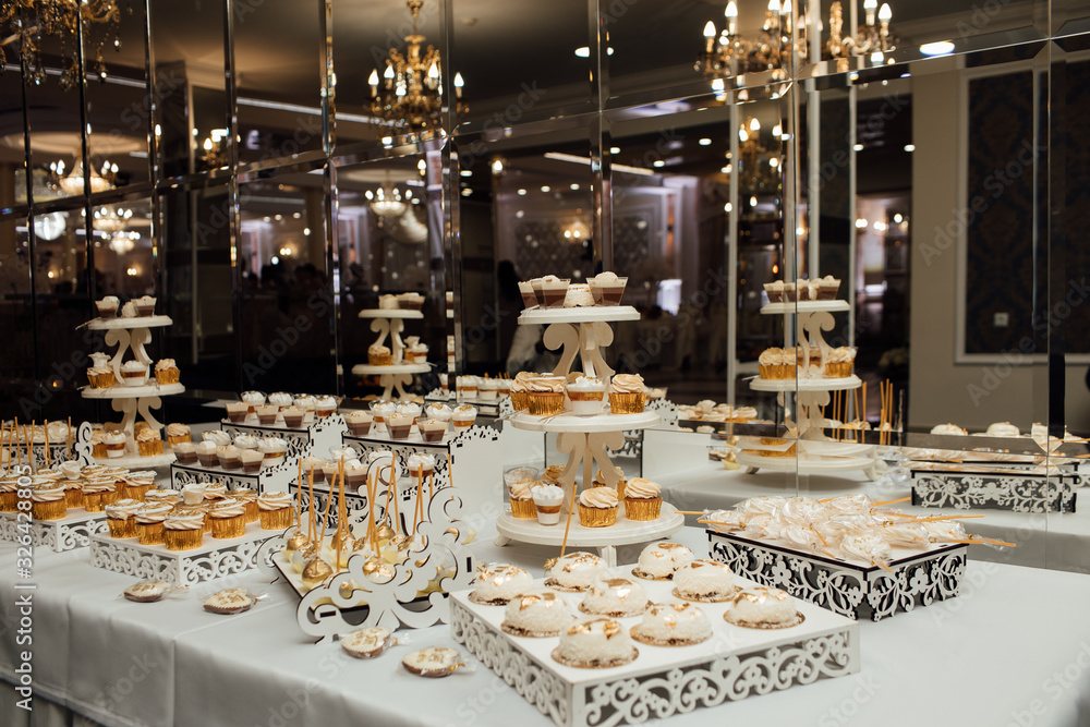 Sweet table. A plates of cakes and muffins. Table with sweets, buffet ...