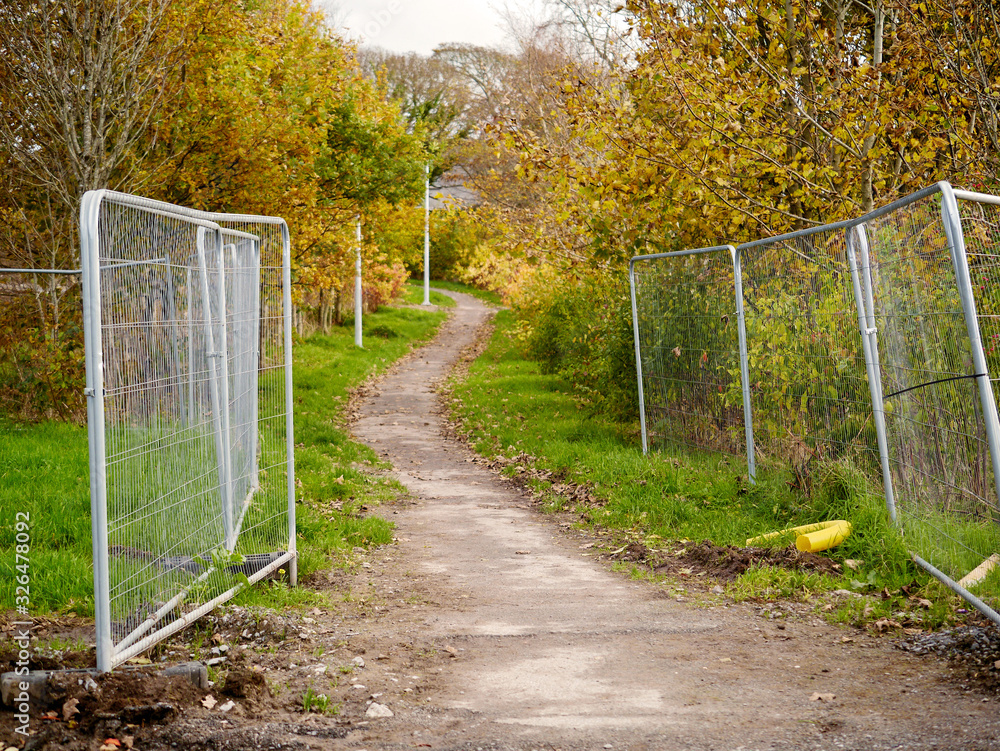 Metal fence by foot path in a park during renovation period. Stock ...