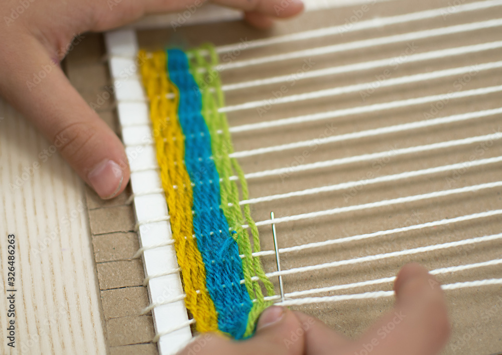Little children hands weaving loom in art theraphy class at school ...