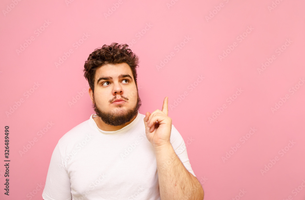 Funny overweight man in white t-shirt isolated on a pink background ...