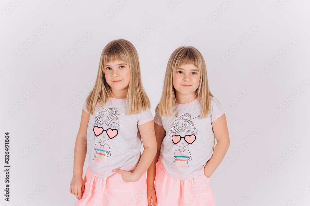 Happy adorable twin blodnie caucasian girls together having fun ...