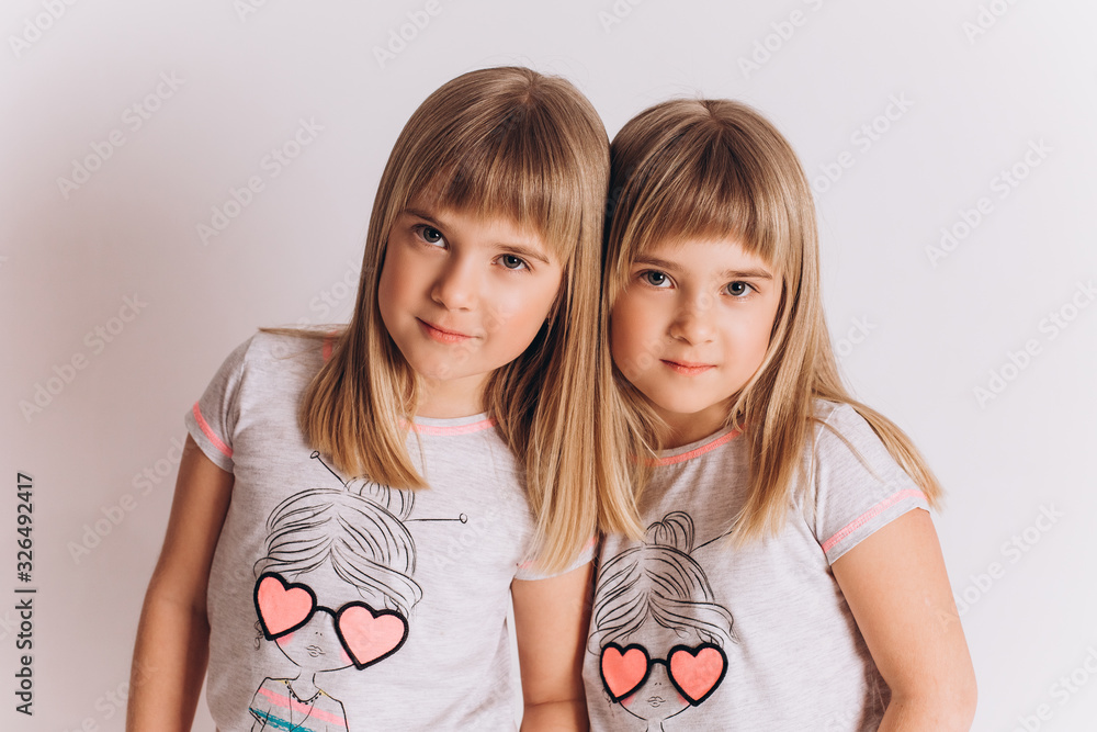 Happy adorable twin blodnie caucasian girls together having fun ...