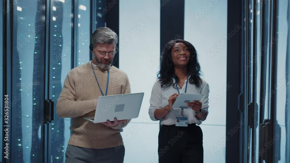 Couple of male and female IT engineers smile cheerful talking ...