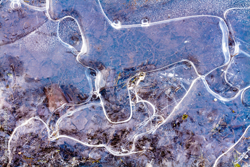 Ice with air bubbles and fancy fault lines, covered with snow in places ...