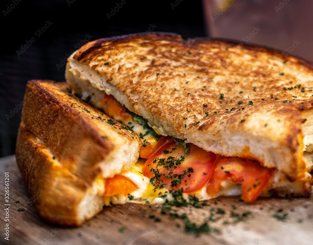 sandwich de pan brioche y queso fundido con tomates cherry y cebollin ...