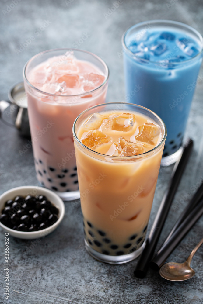 Variety of milk bubble tea in tall glasses, strawberry, butterfly tea ...