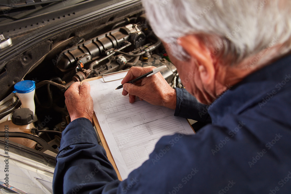 Mechanic with checklist at main inspection Stock Photo | Adobe Stock