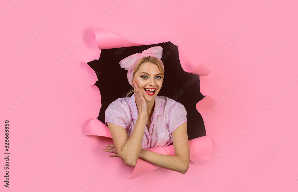 Through paper. Woman peeks through hole in paper. Pin up woman looking ...
