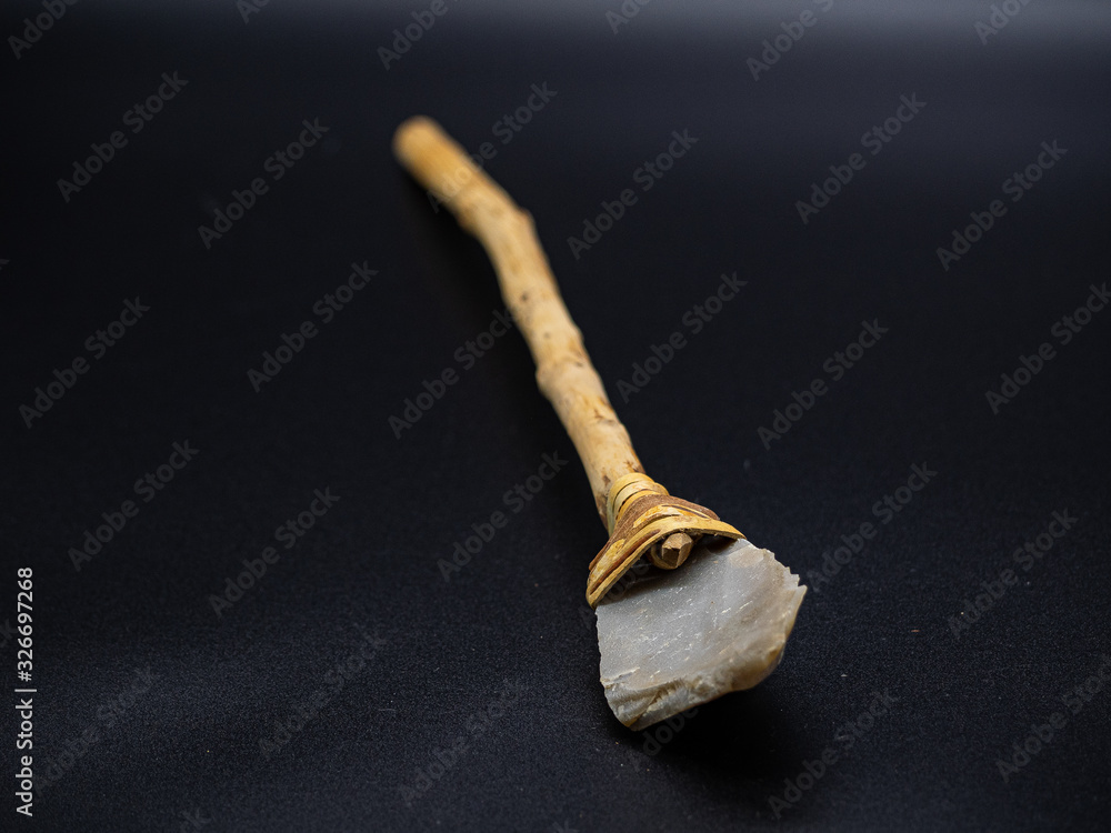 Replica of the primal stone tool with wooden handles and leather ...