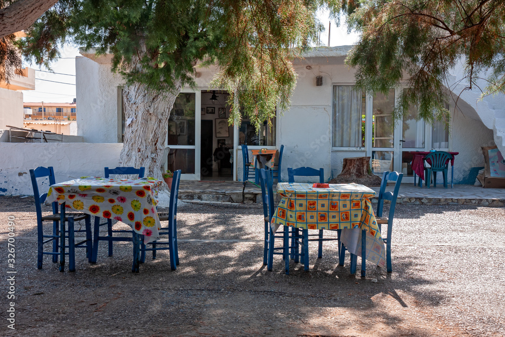 Tables and chairs of a typical restaurant on the coast of the island of ...