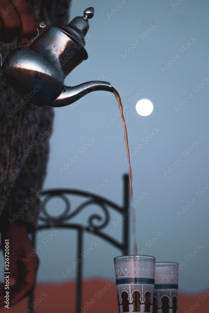 Tea, berber whisky ritual. Pouring from the kettle to the glasses on ...