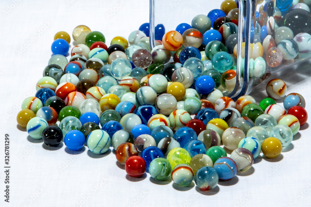 Marbles spill from container 222 Stock Photo | Adobe Stock