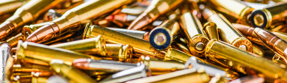 Pile of fire bullets or ammunition banner or panorama on dark stone ...