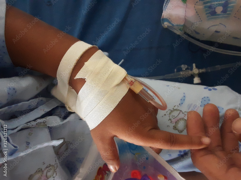 The hand of the child giving the saline solution Stock Photo | Adobe Stock