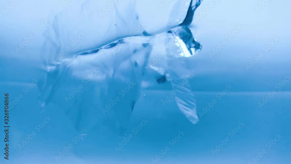 slow motion Underwater Sea scene view Plastic trash bag floating in the ...