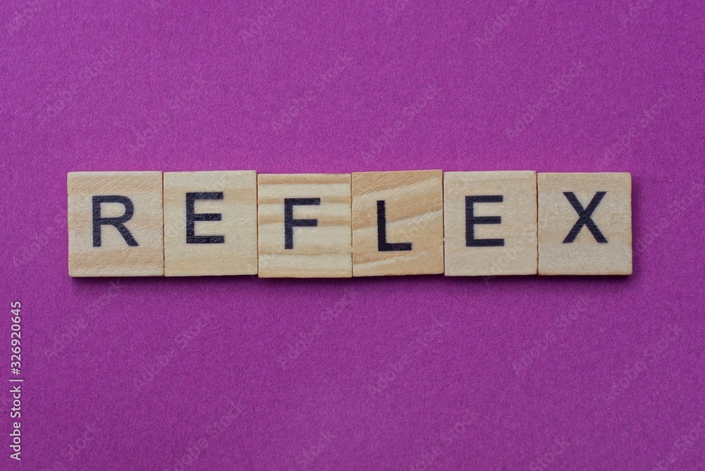 word reflex from small gray wooden letters lies on a lilac background ...