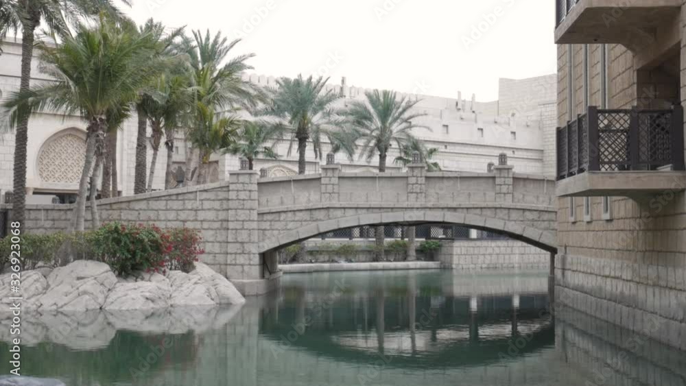 Exterior day shot: a bridge over still waters in Souk Madinat Jumeirah ...