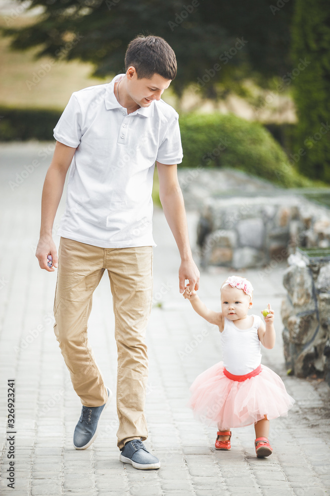 Father holding his little cute baby by the hand. Dad and his daughter ...