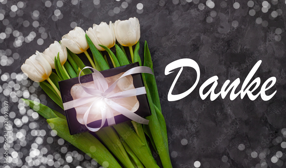 Danke Thank You in German card message sign. White tulip flowers and ...