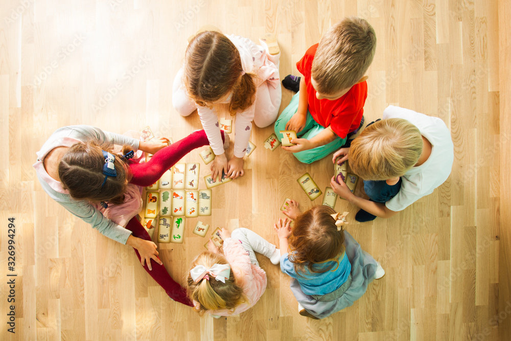 Children playing with puzzle cards for child development in play room ...
