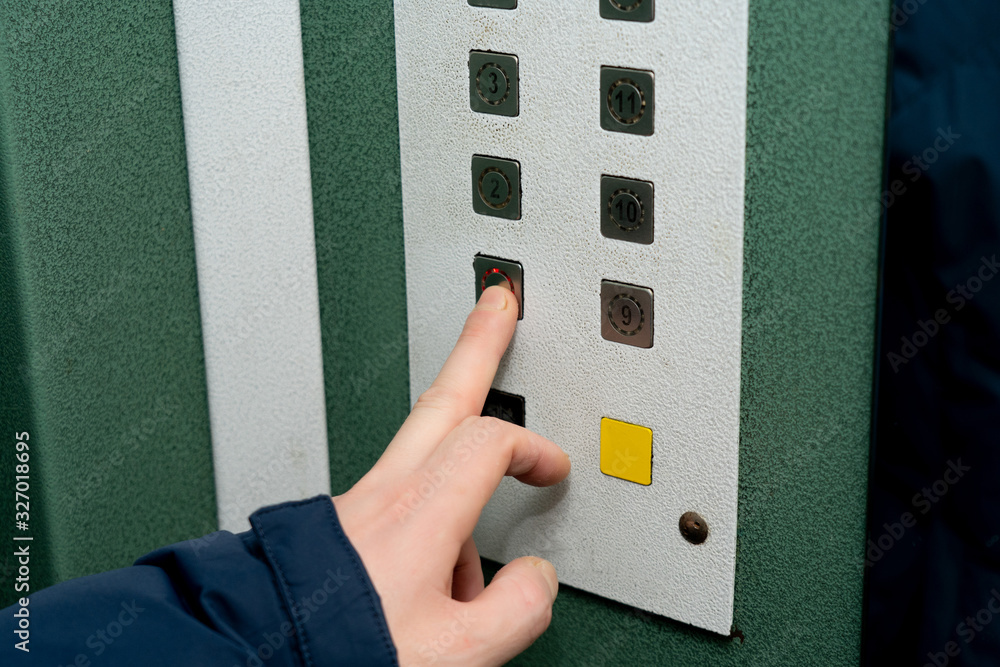Pressing the button in the elevator Stock Photo | Adobe Stock