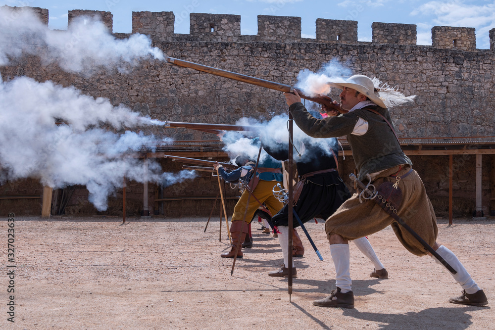 PortraGroup of musketeers in the palenque of a castle, doing shooting ...