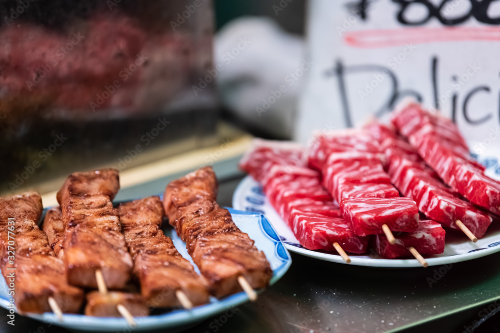 Kyoto, Japan Nishiki market shop food vendor selling wagyu kobe beef ...