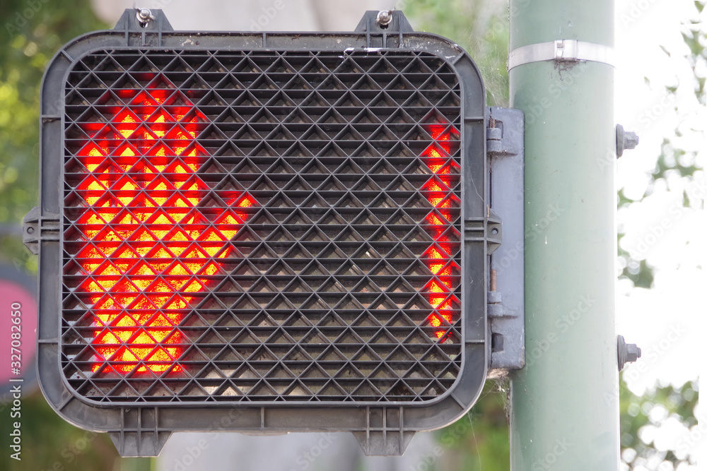 Pedestrian crosswalk traffic signal at a city intersection with a red ...