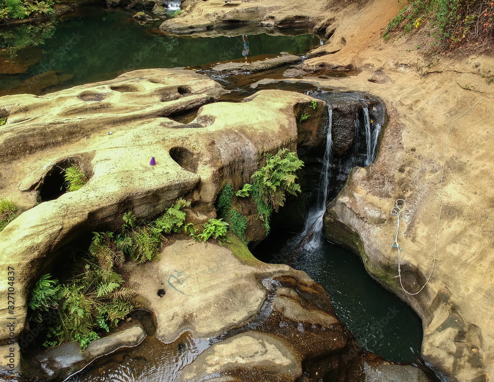 Impressive Potholes Falls in gold bedrock in a gorge setting with ...