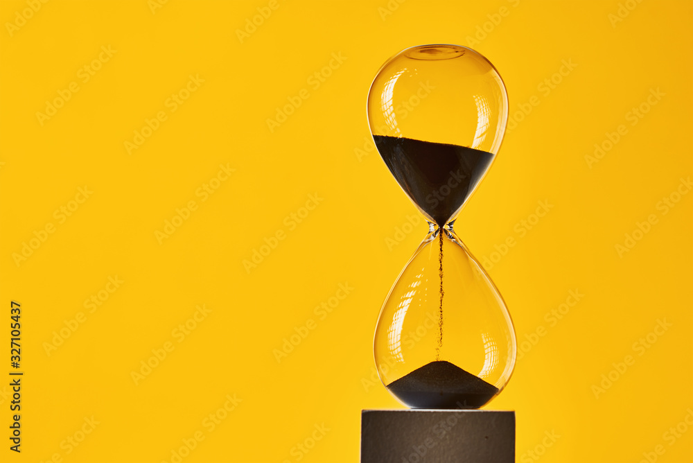 Hourglass on the yellow background with copy space. Concept of running ...