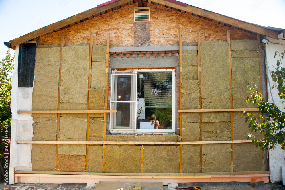 warming the walls of a stone house with a stone wool heater. Ecological ...